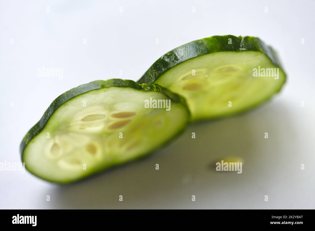 Two slices of fresh cucumber with backlit Stock Photo - Alamy