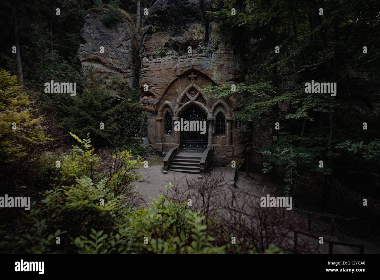 Ancient and abandoned rock chapel hidden in deep forest in the north ...