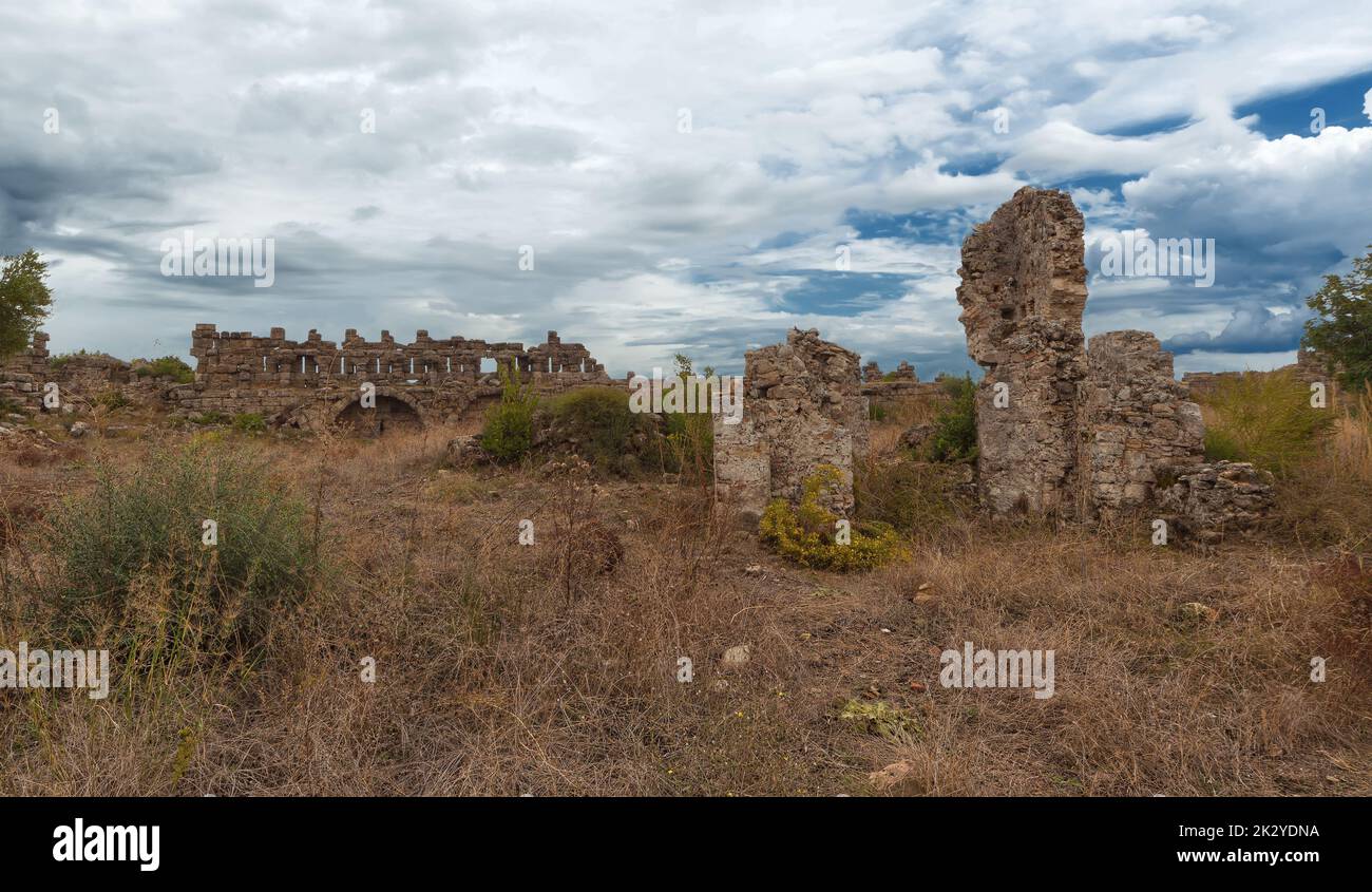 The ruins of the ancient city wall and buildings in an abandoned area ...