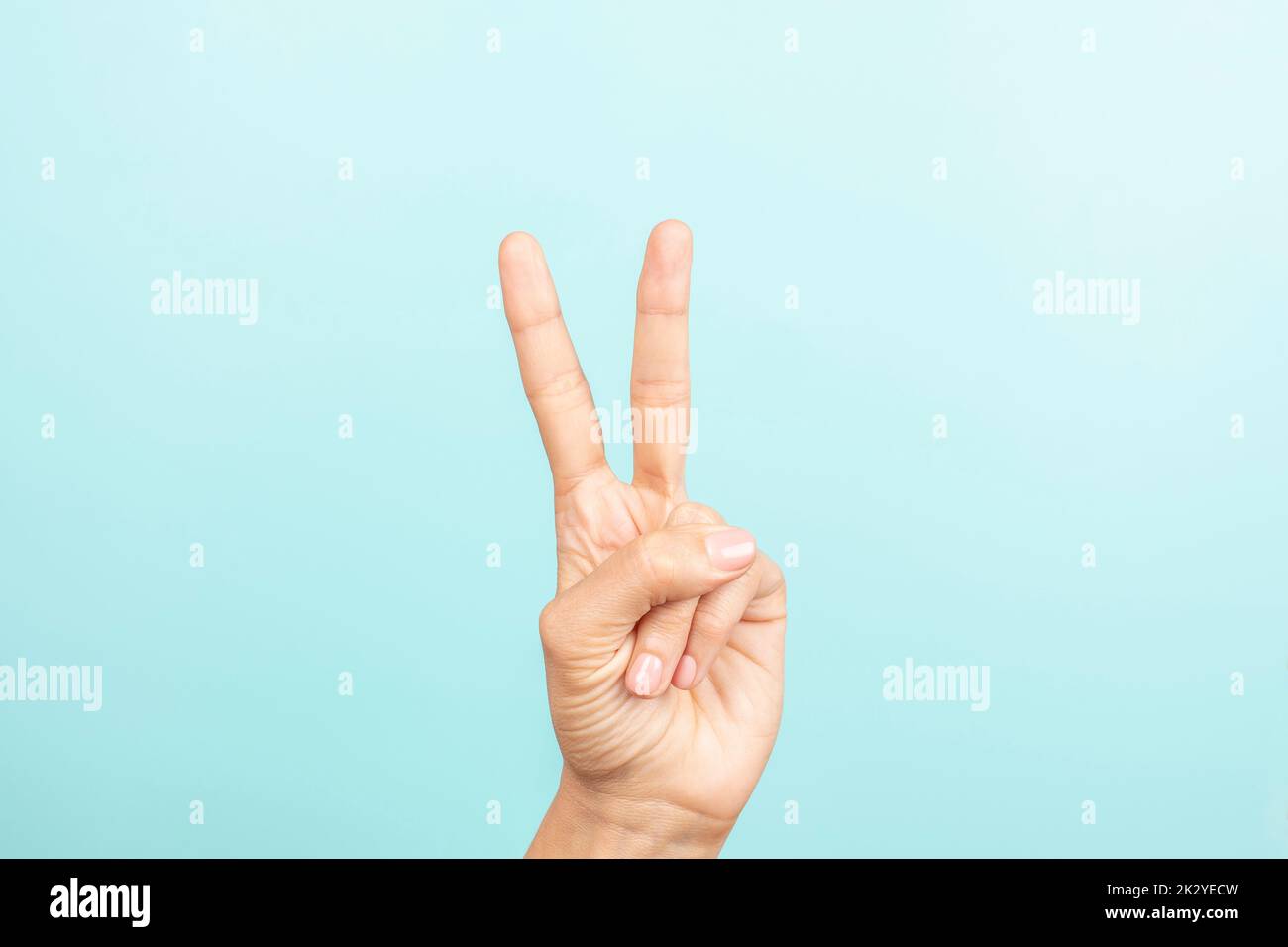 Hand gesture. Female hand shows number two. Hand gesturing victory ...