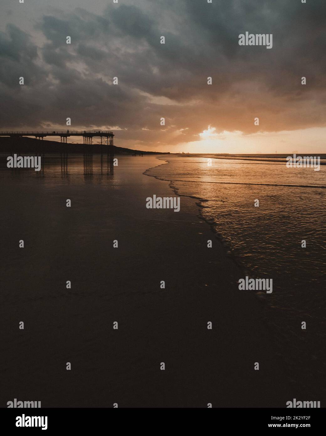 A silhouette shot of the pier at Saltburn beach in Saltburn-by-the-Sea ...