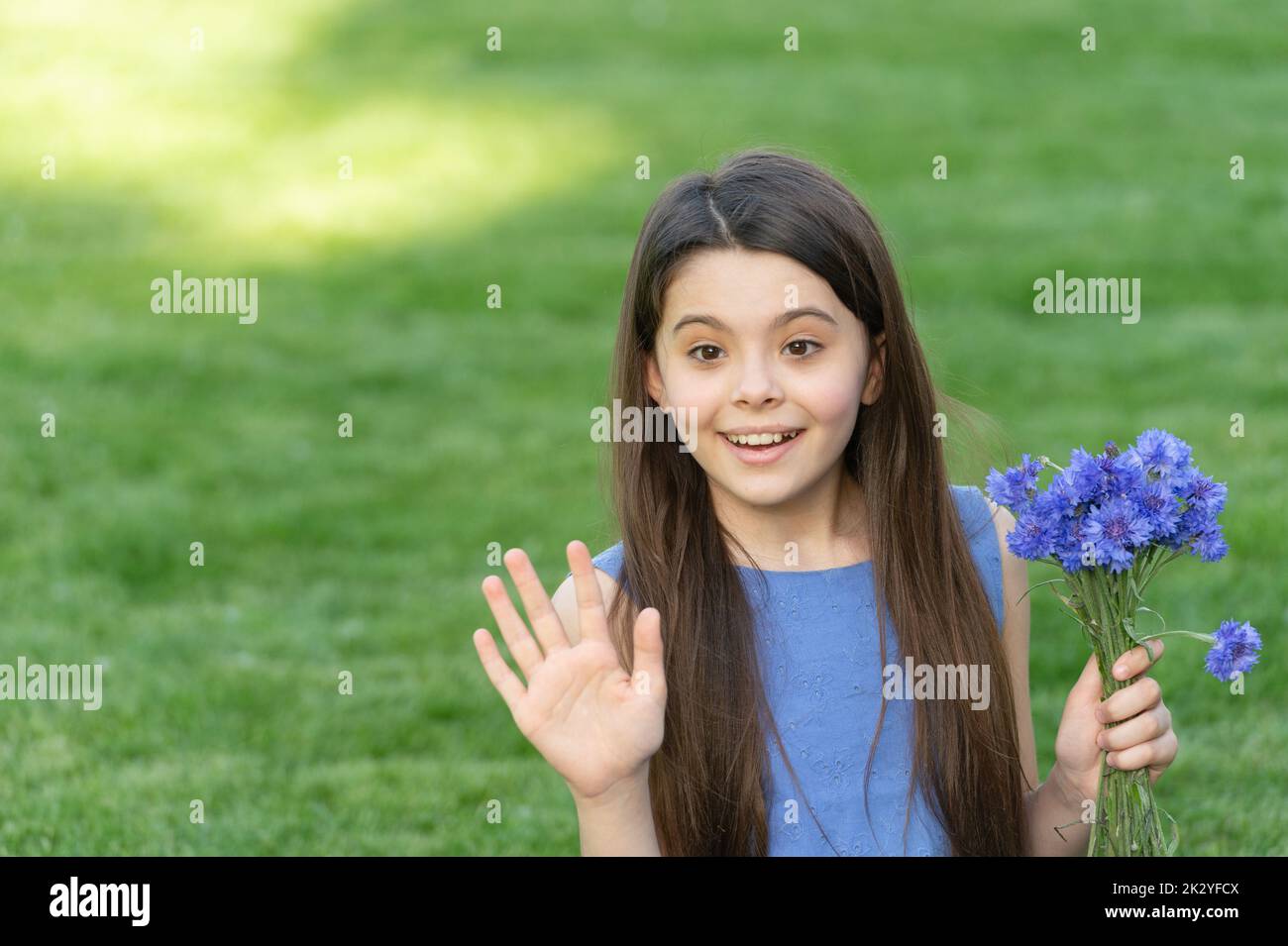 amazed teen girl with flowers. pretty girl on grass. cute girl portrait ...