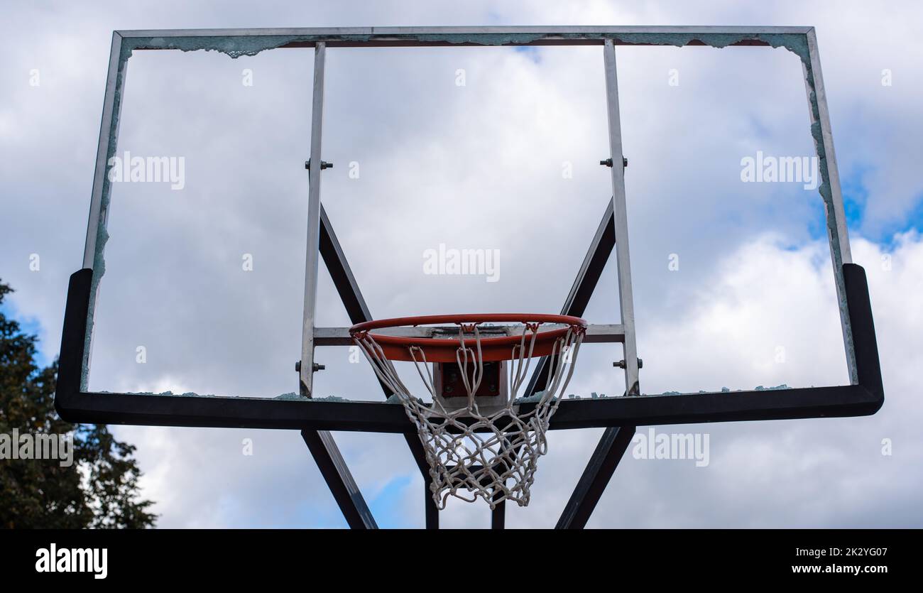 Broken glass backboard and broken hoop on the basketball court Stock ...