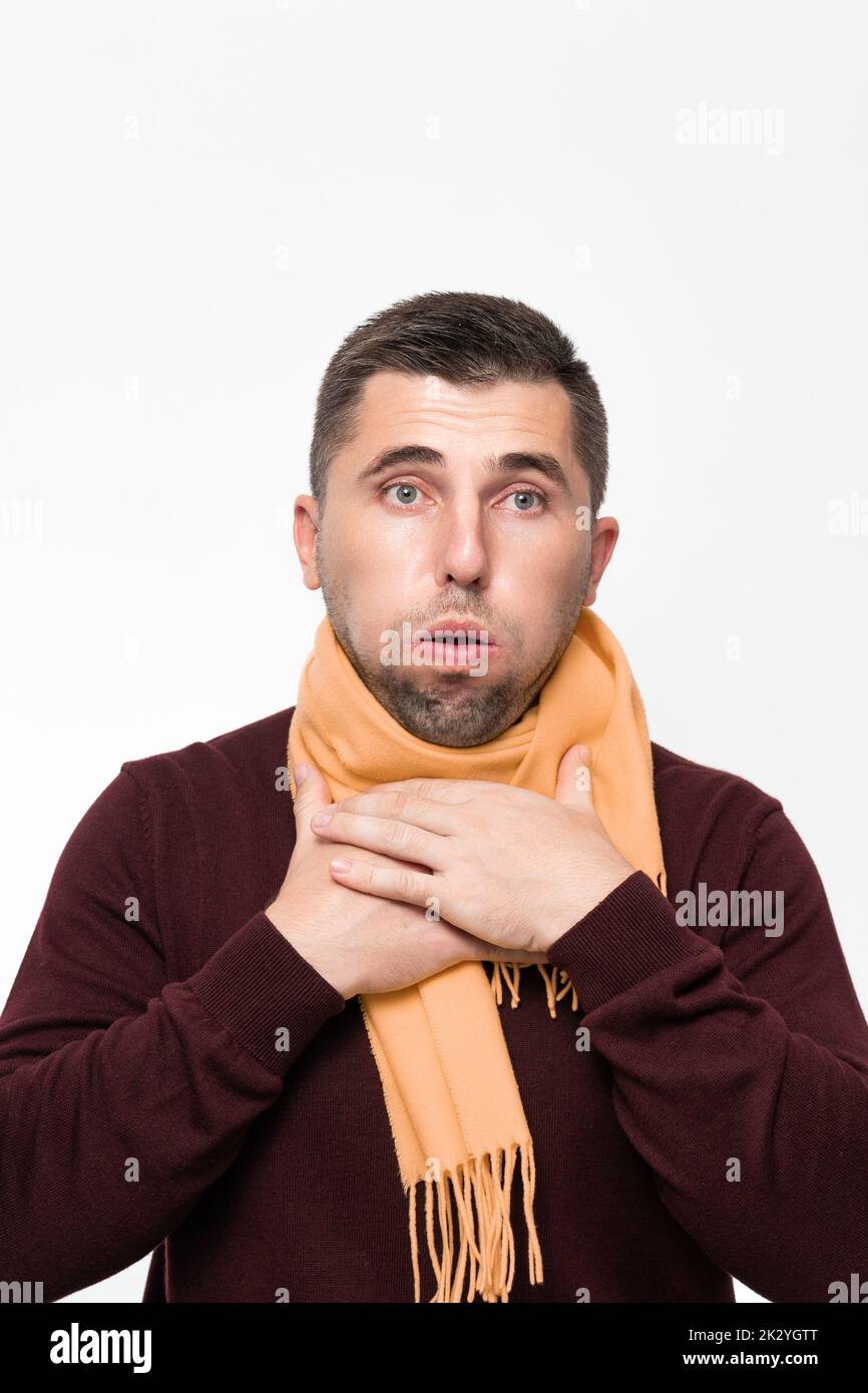 A man suffers from a sore throat, a man wrapped his throat with a scarf ...