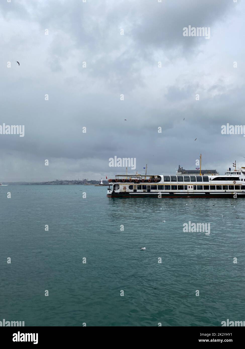 A vertical of an anchored ship in Marmara sea in Istanbul under a grey ...