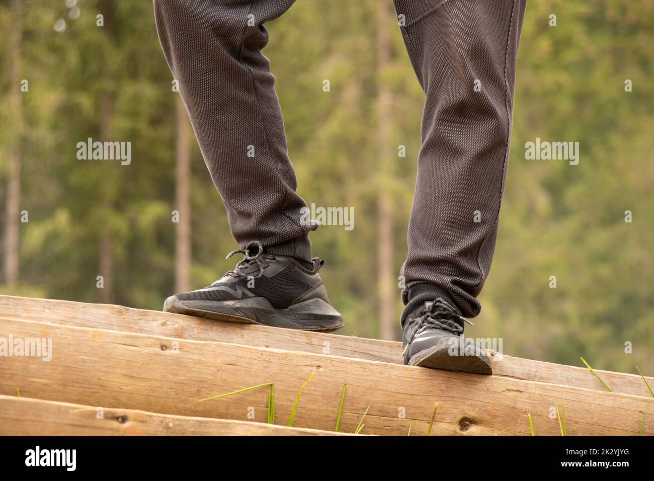 A man climbs the stairs on a sunny day in Ukraine, feet on the steps ...