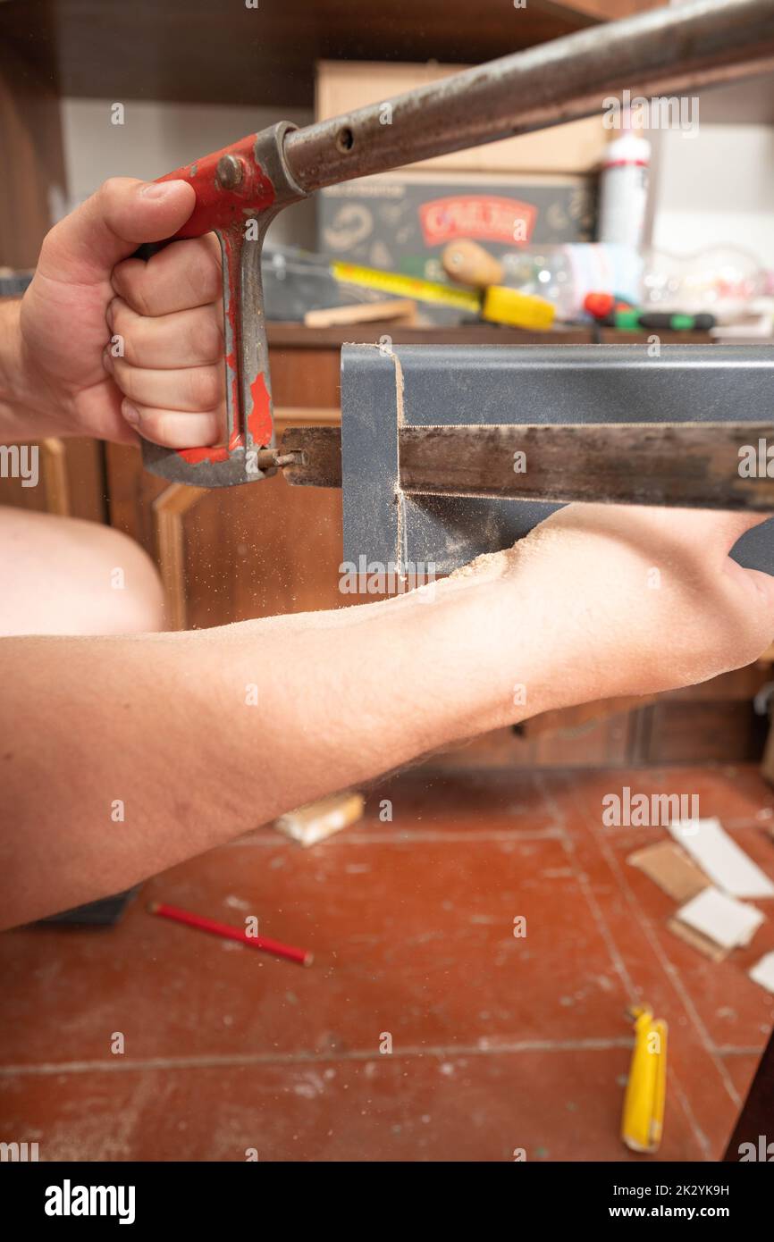 Trimming a wooden plinth with a hand jigsaw, hand tool jigsaw and ...