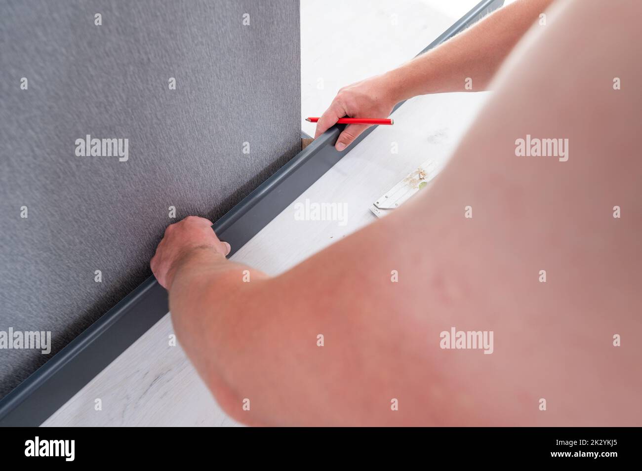Wooden plinth in the room, installation of the plinth by a master ...