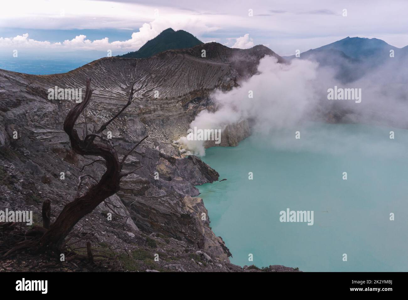 An aerial view of a blue acid lake with sulfur steam near Mount Ijen ...
