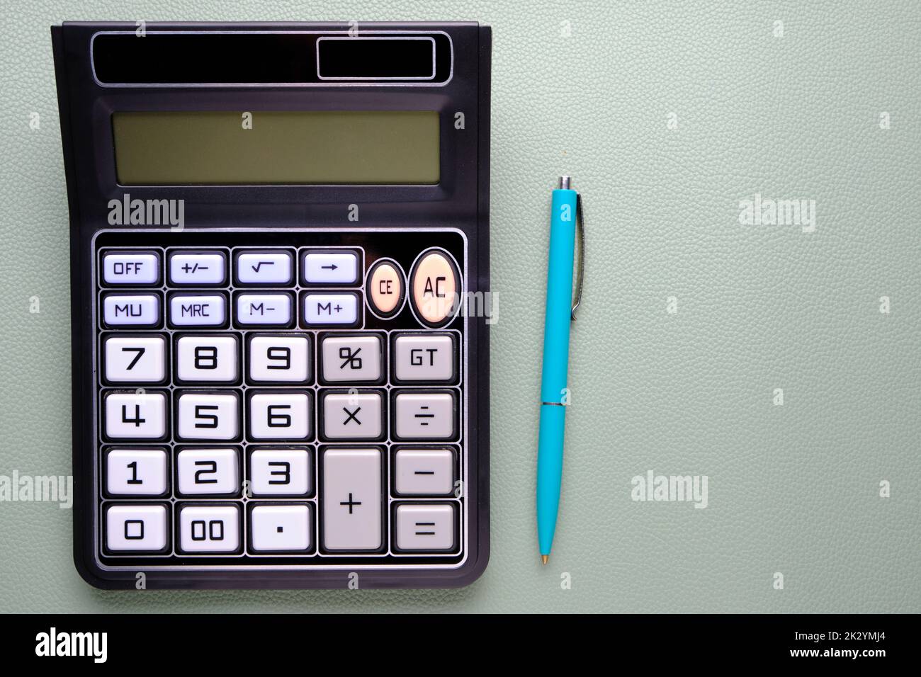 Calculator with a ballpoint pen on a leather texture background Stock ...