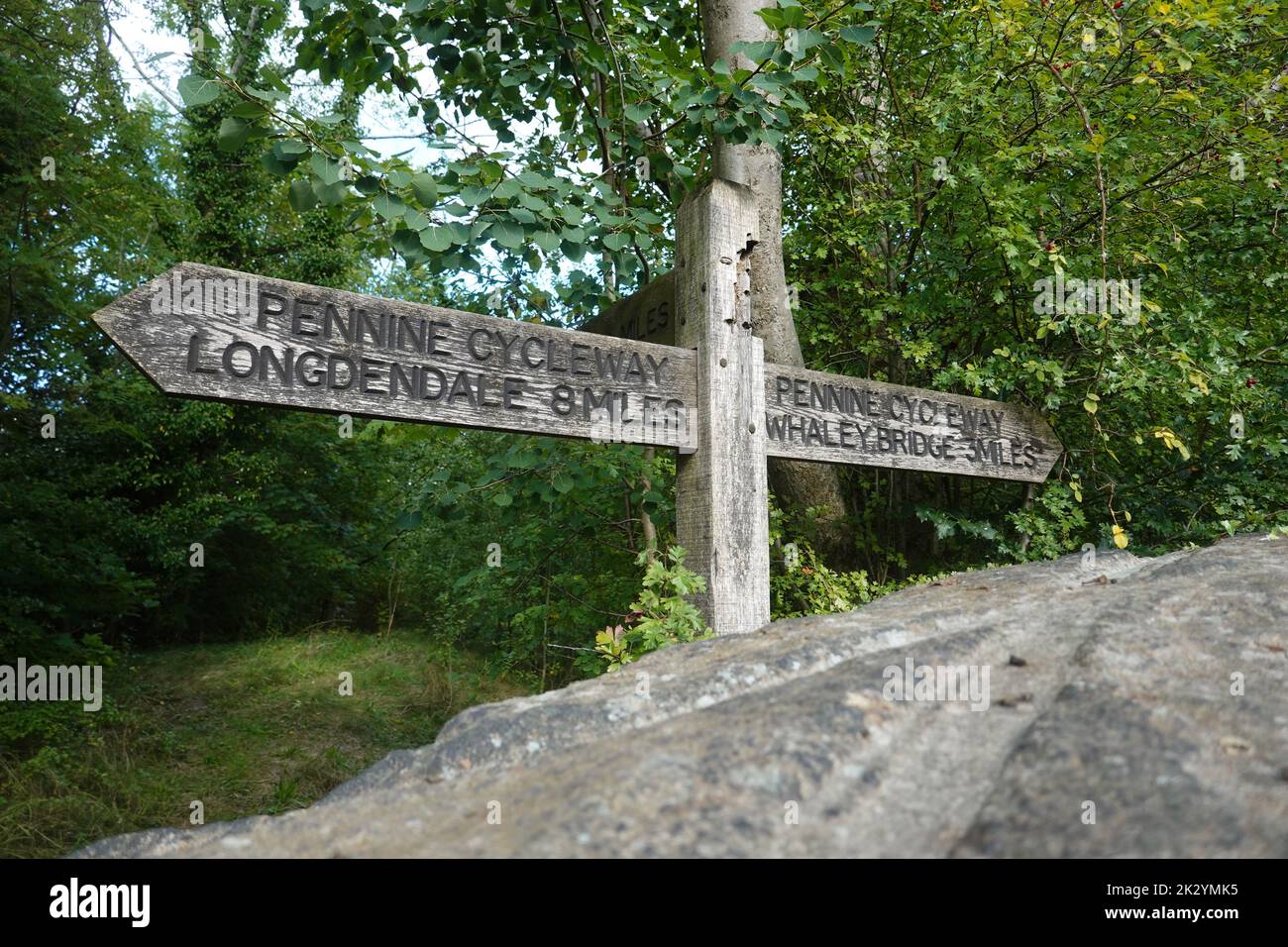Wooden sign giving direction in New Mills, Derbyshire Stock Photo - Alamy