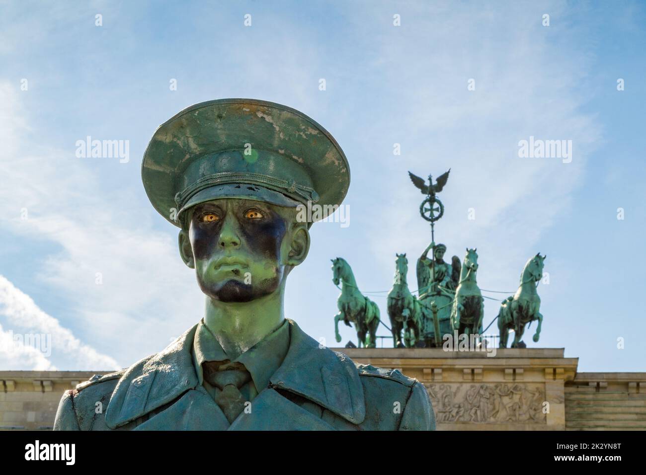 A green lifelike doll of a German soldier in front of the Brandenburger ...