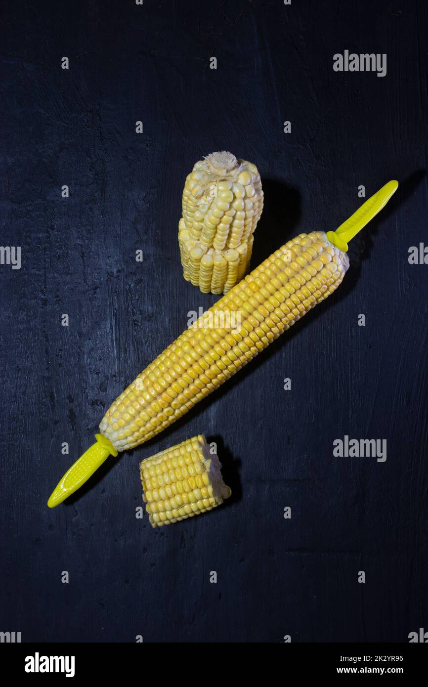A top view shot of corn (maize) on a black hard surface Stock Photo - Alamy