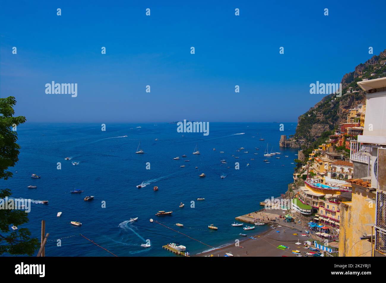 A beautiful seascape full of boats in front of the coastal Positano ...