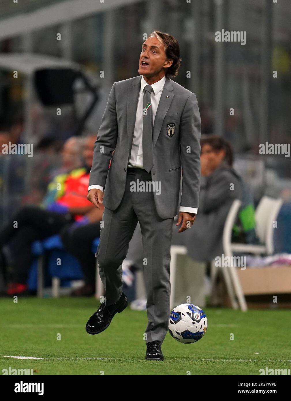 Italy manager Roberto Mancini backheels the ball on the touchline ...