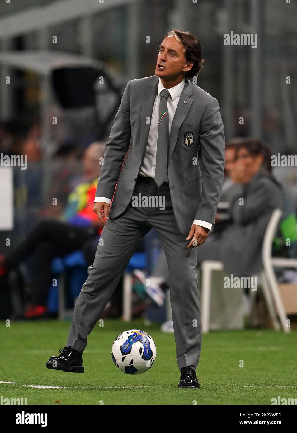 Italy manager Roberto Mancini backheels the ball on the touchline ...