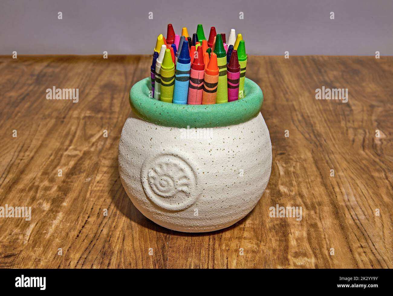 A close up of a cute round white and turquoise ceramic holder with a ...