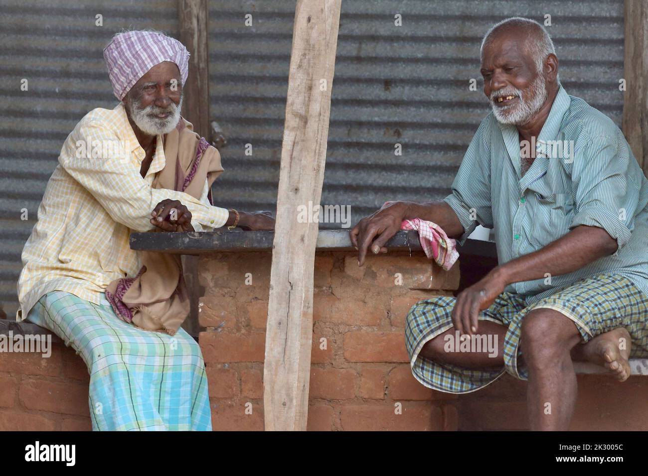 Two old Indian village men having a deep conversation in an abandoned ...