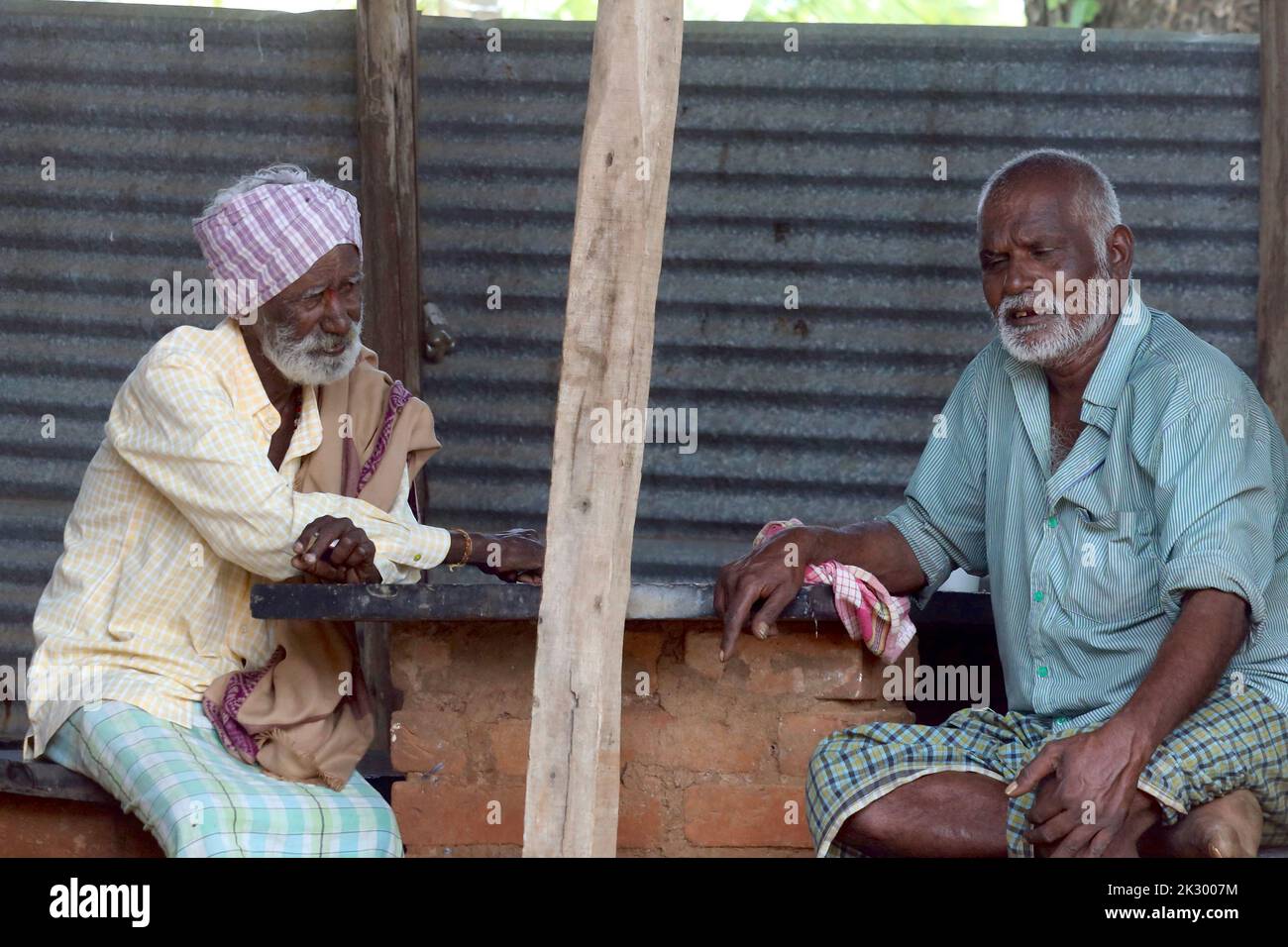 Two old Indian village men having a deep conversation in an abandoned ...