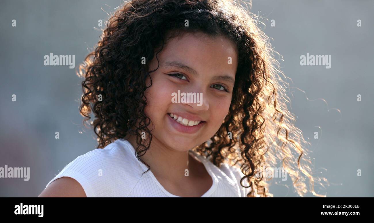 Beautiful Brazilian child smiling at camera standing outside Stock ...