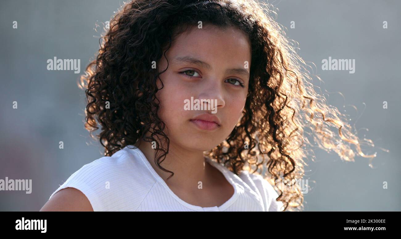 Beautiful Brazilian child smiling at camera standing outside Stock ...
