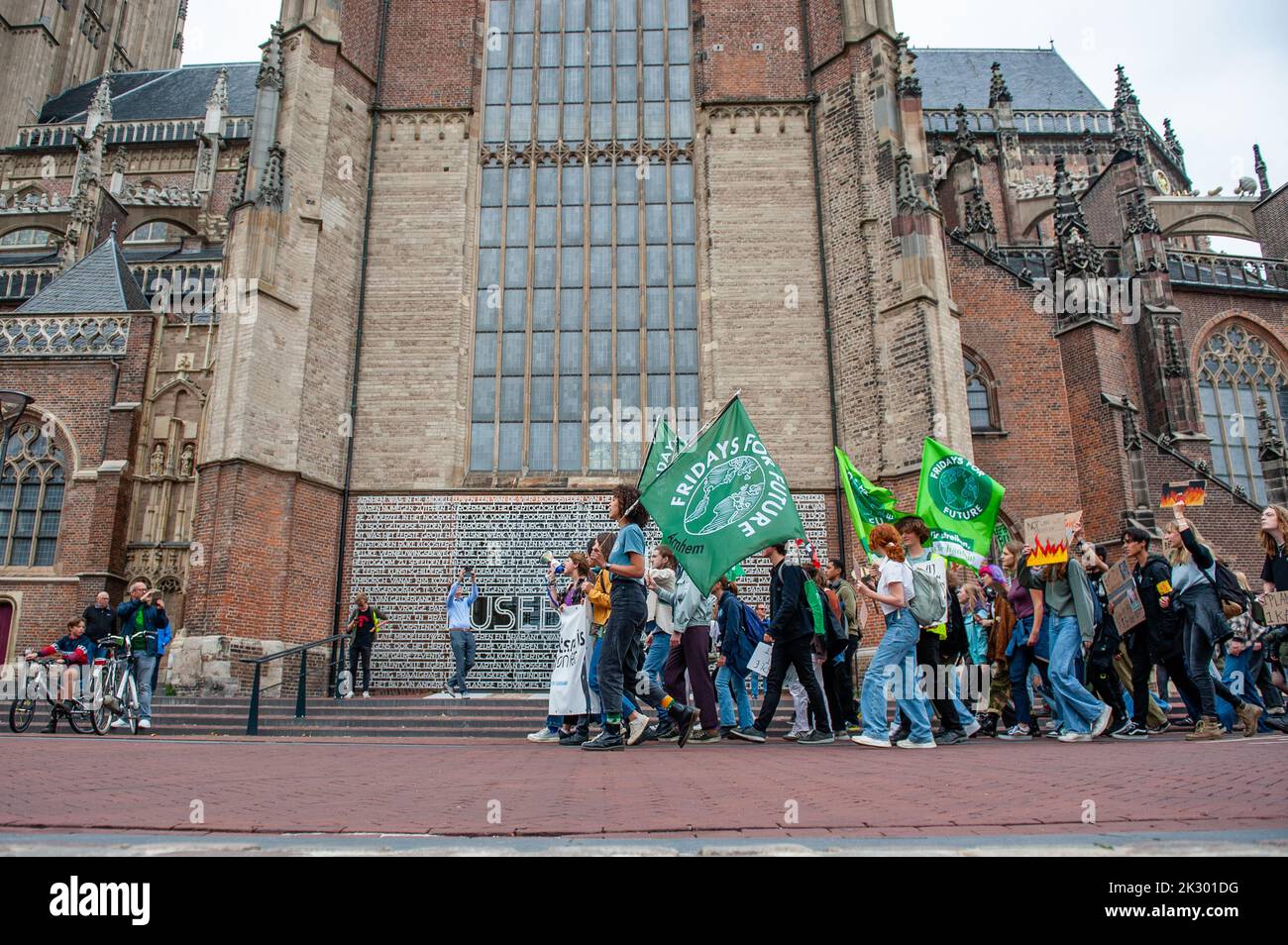 Protesters are seen passing in front of a church while holding flags ...