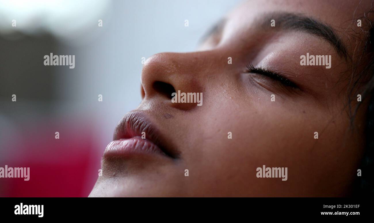 Black girl closing and opening eyes to sky praying and spiritual Stock ...