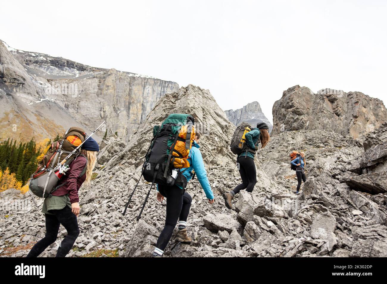 Female hikers climbing rugged mountain slope hi-res stock photography ...