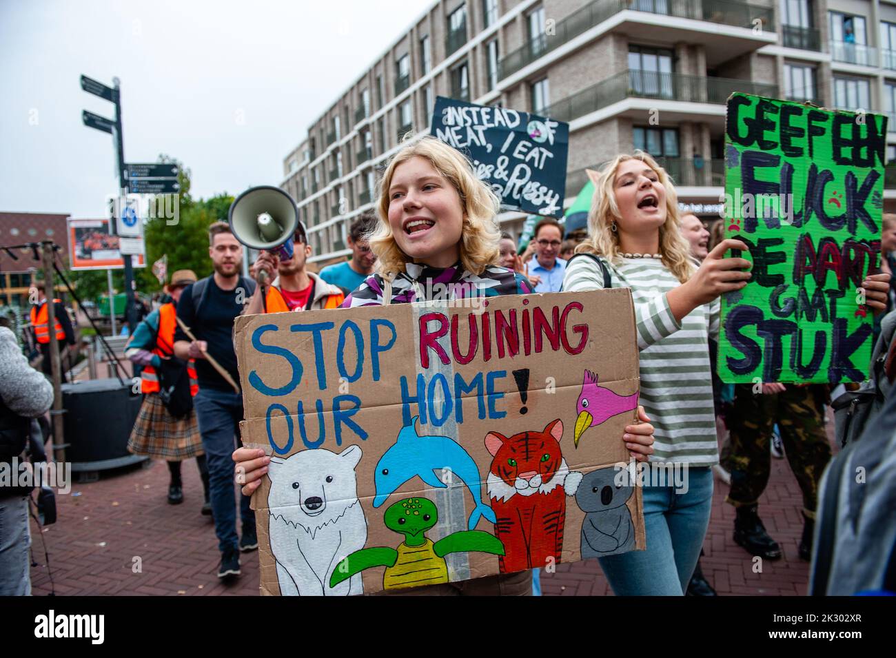 A woman is seen holding a big placard in support of animals and nature ...