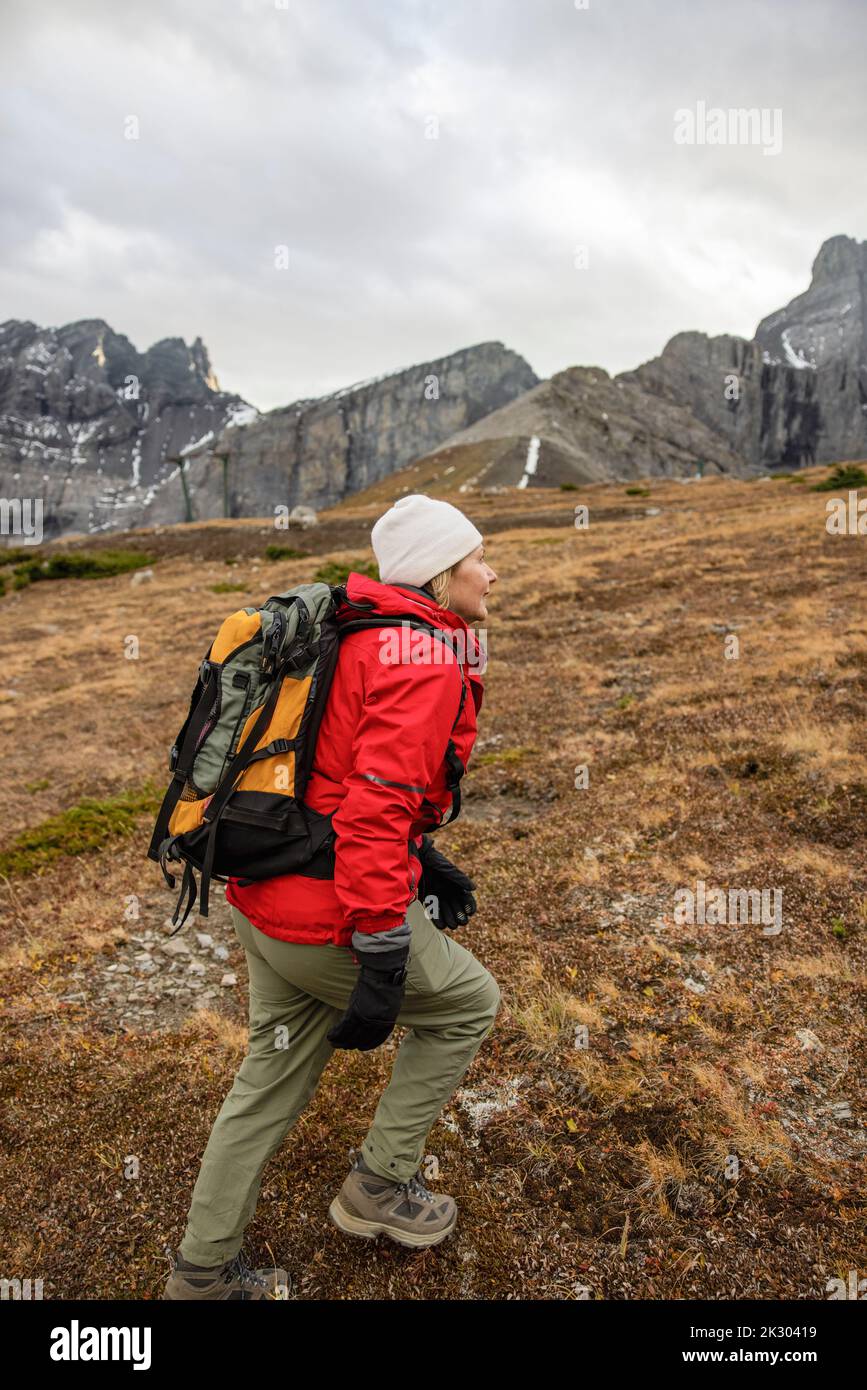 Woman hiking up remote mountain slope hi-res stock photography and ...