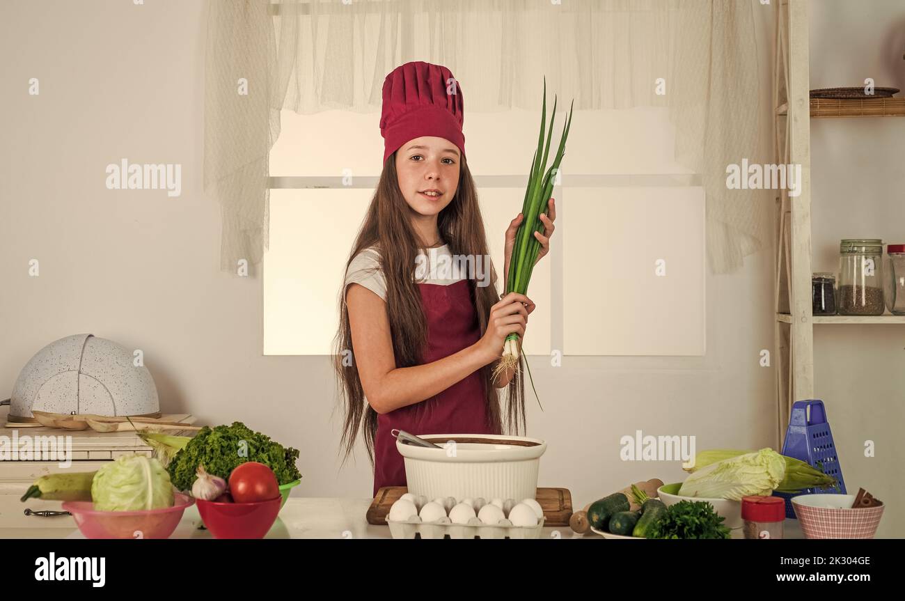 child girl cooking meal from healthy and organic products only, onion ...