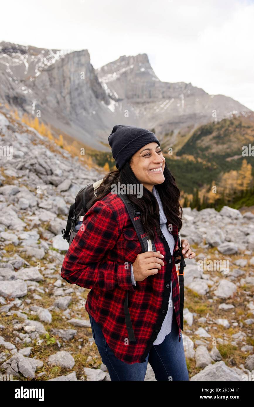 Happy woman hiking in remote rocky mountains hi-res stock photography ...