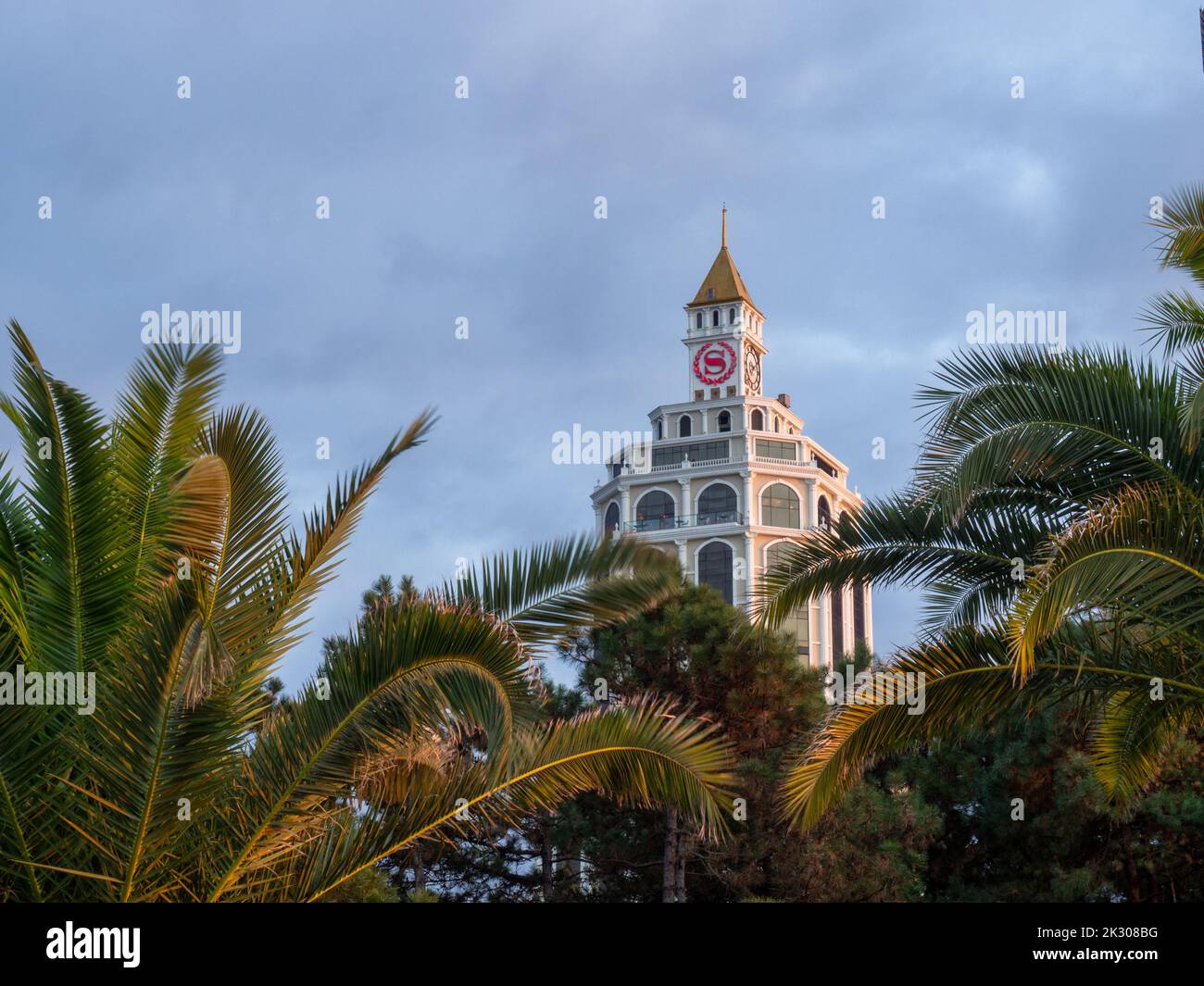 Unusual tall building. House with tower and clock. Modern architecture ...