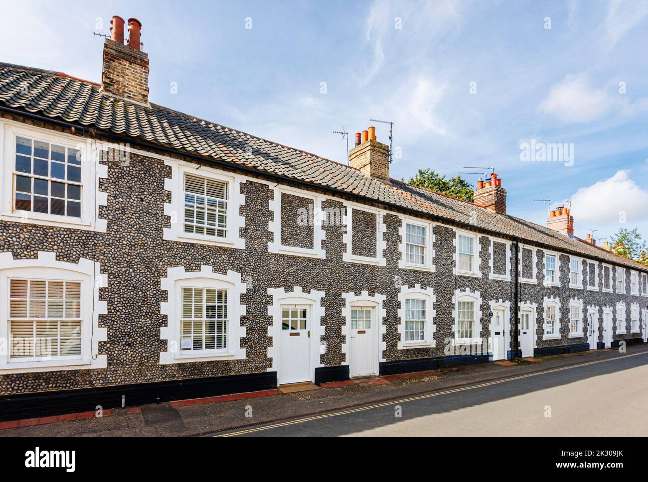 Terrace of local architectural style houses with flint stone walls in ...