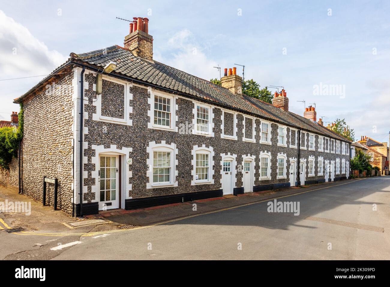 Terrace of local architectural style houses with flint stone walls in ...