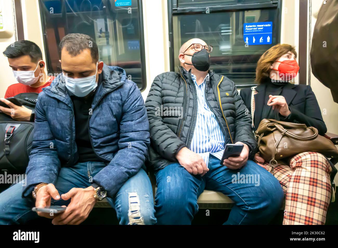 People commuters passengers in PPE face masks inside Madrid metro ...