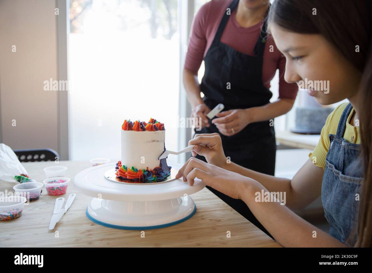 Child decorating cake hi-res stock photography and images - Alamy