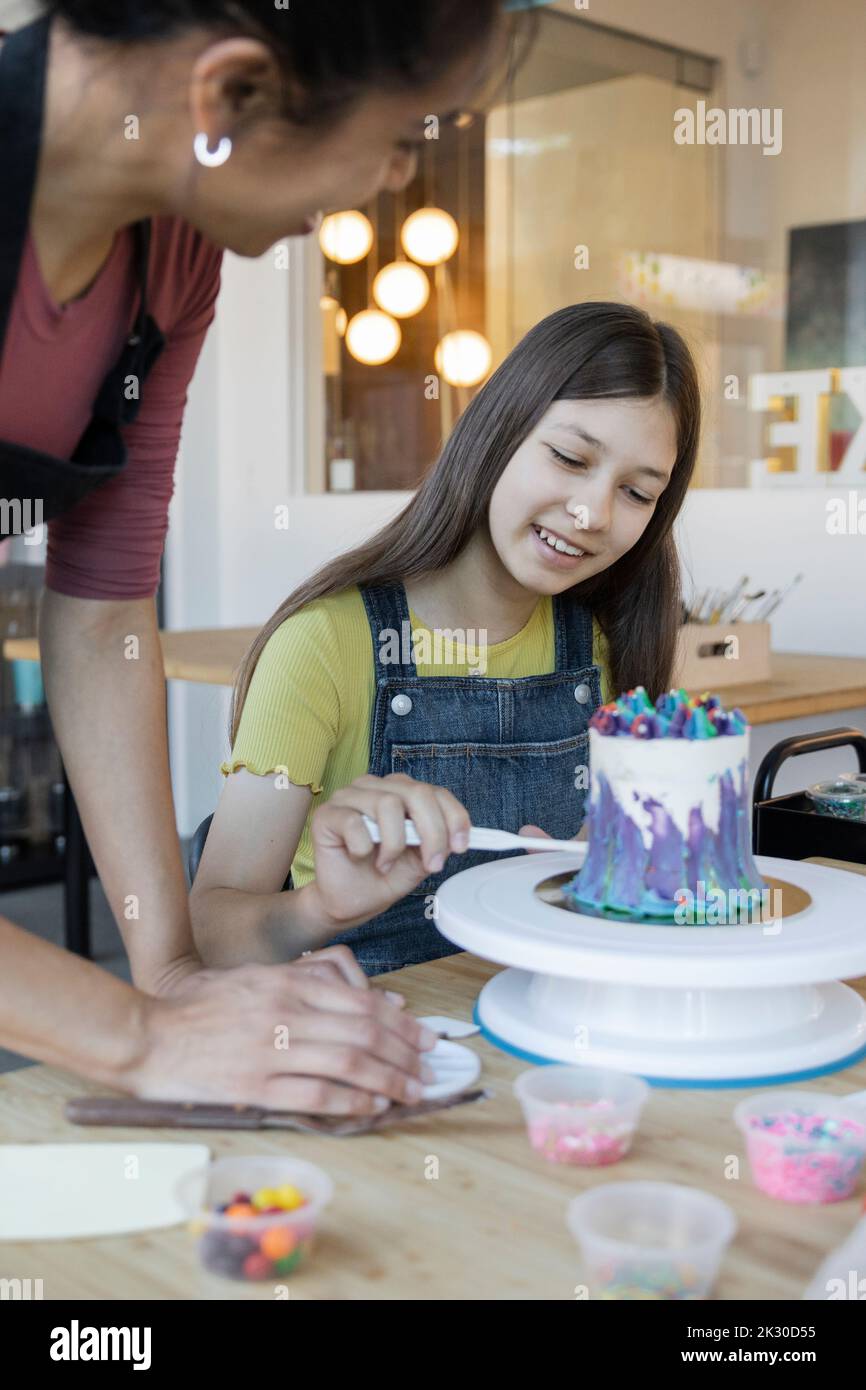 Child decorating cake hi-res stock photography and images - Alamy