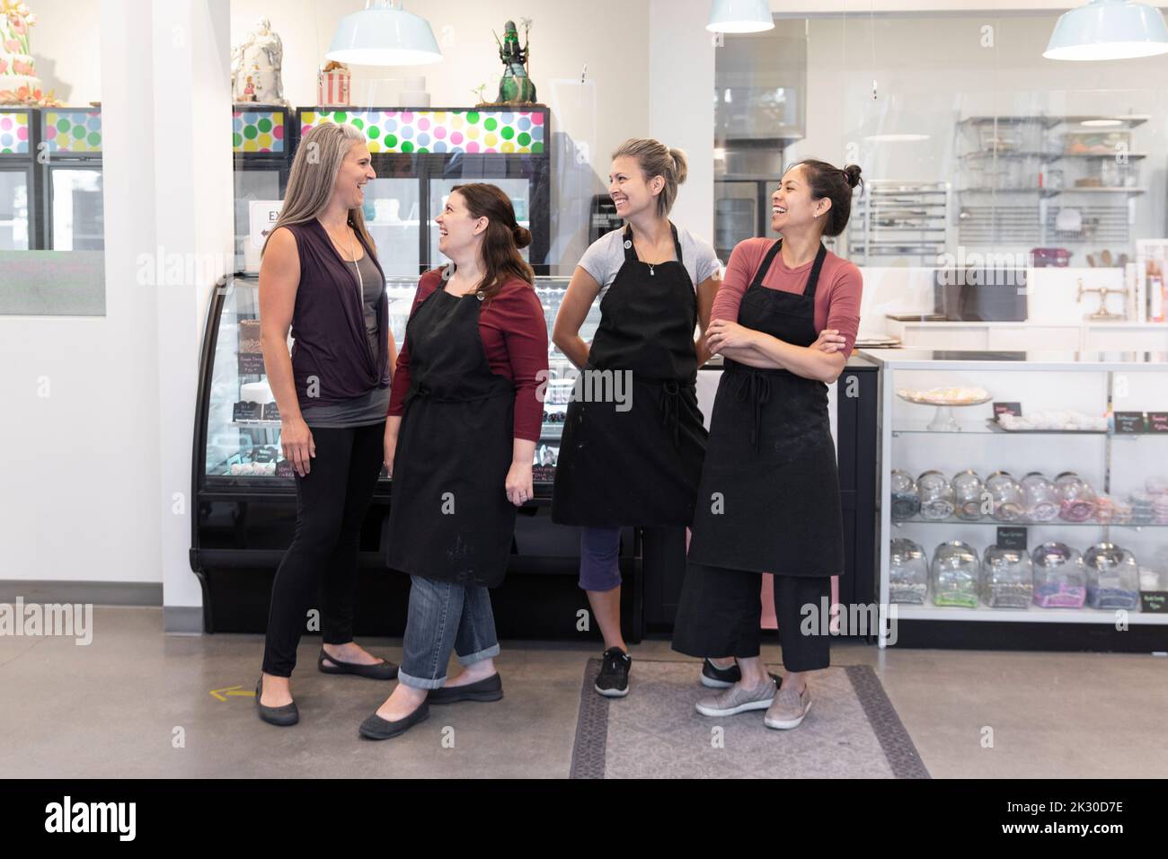 Four colleagues talking in bakery shop Stock Photo - Alamy