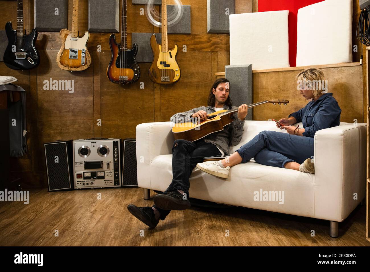 Woman sitting on couch hi-res stock photography and images - Alamy