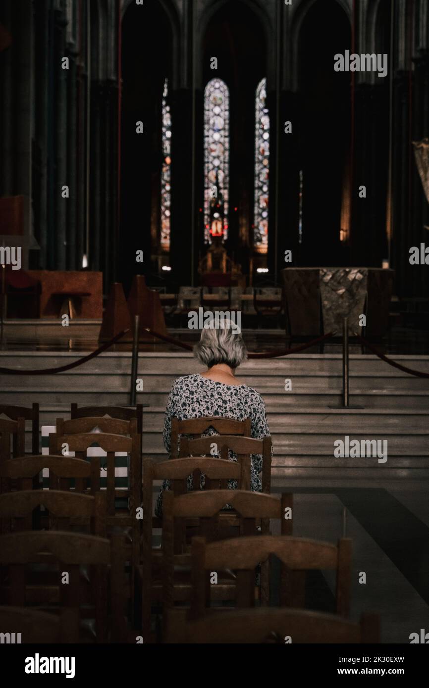 An old woman from the back sitting in St. Peter's Basilica in France ...