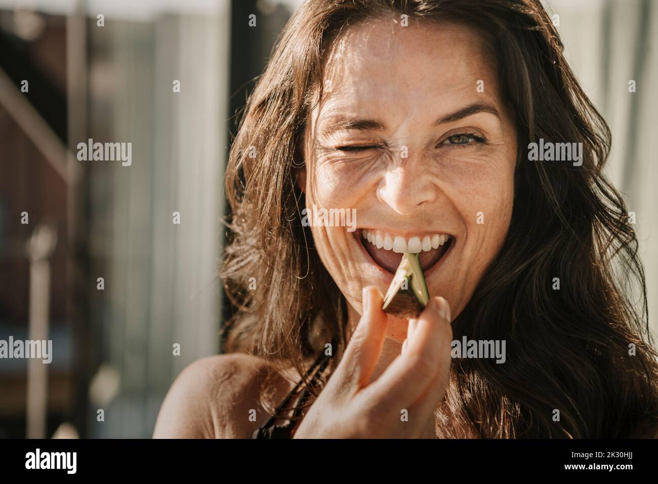 Close up woman winking eye hi-res stock photography and images - Alamy