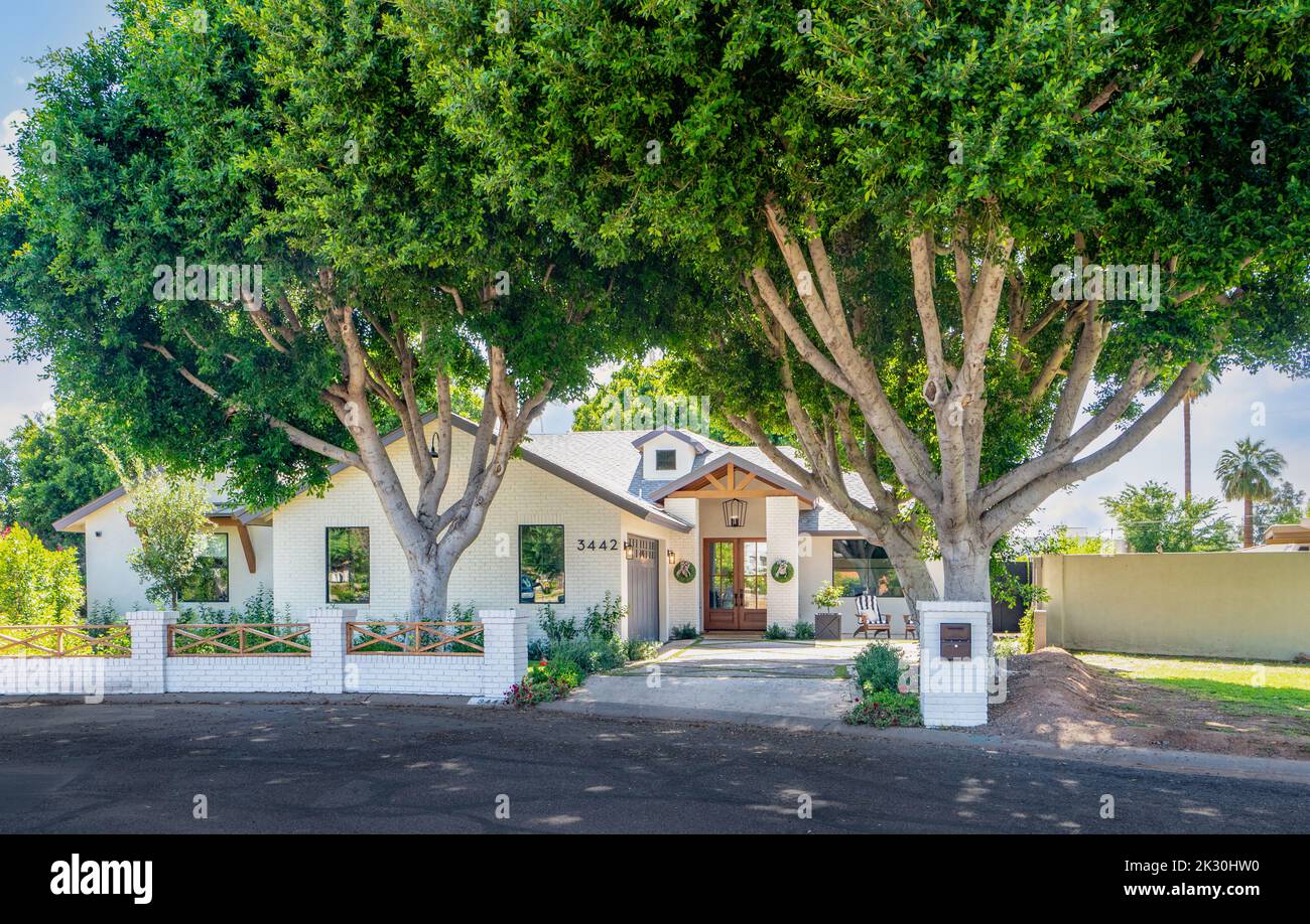 a white home with large trees Stock Photo - Alamy
