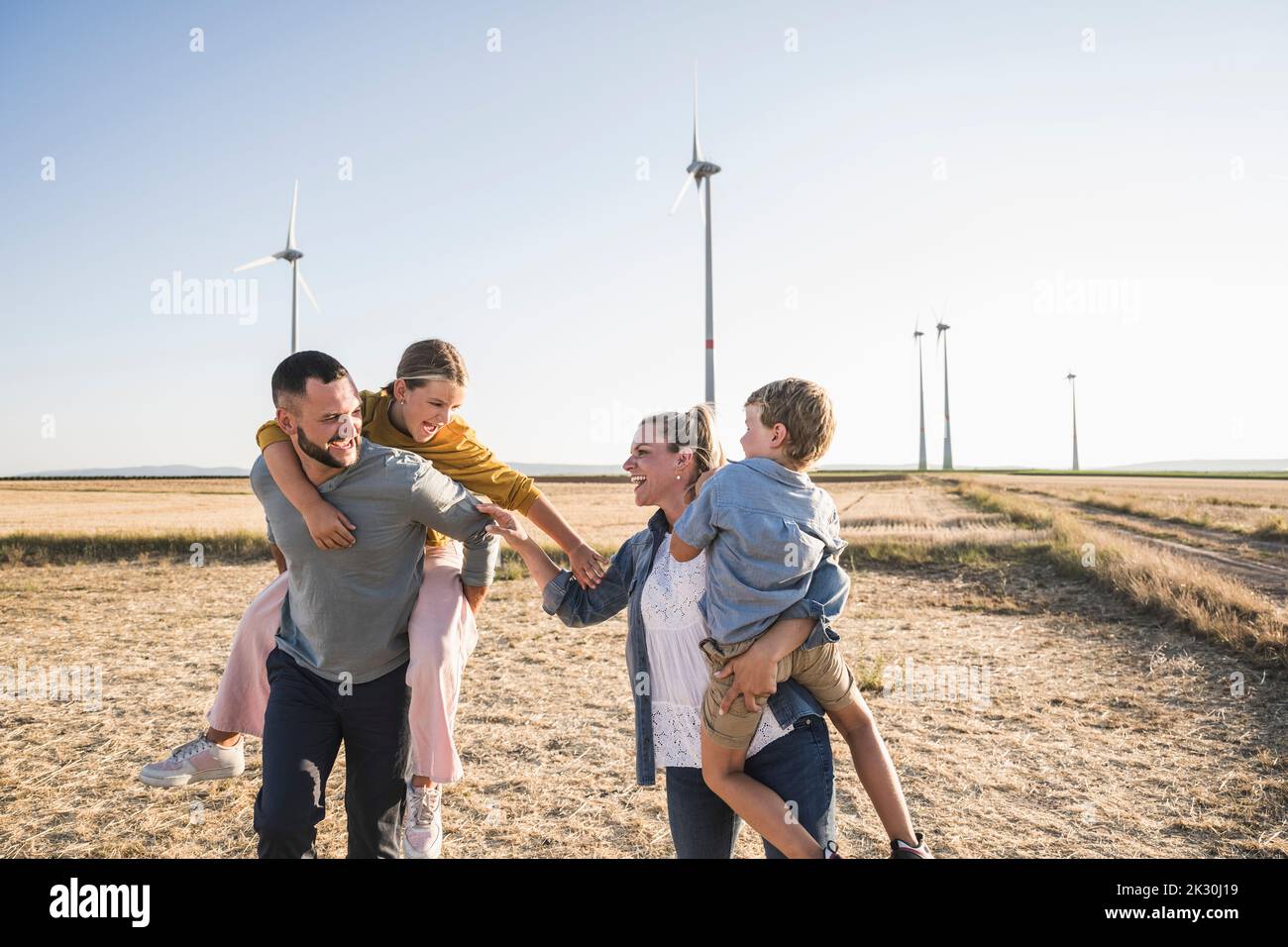 Confident family standing in wind park holding hands Stock Photo - Alamy