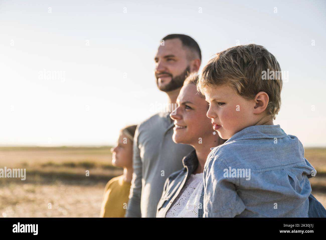Confident family looking at distance Stock Photo - Alamy
