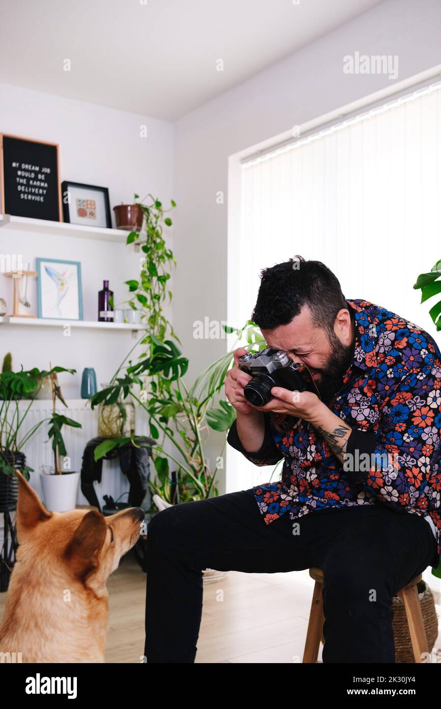Man photographing pet dog at home Stock Photo - Alamy