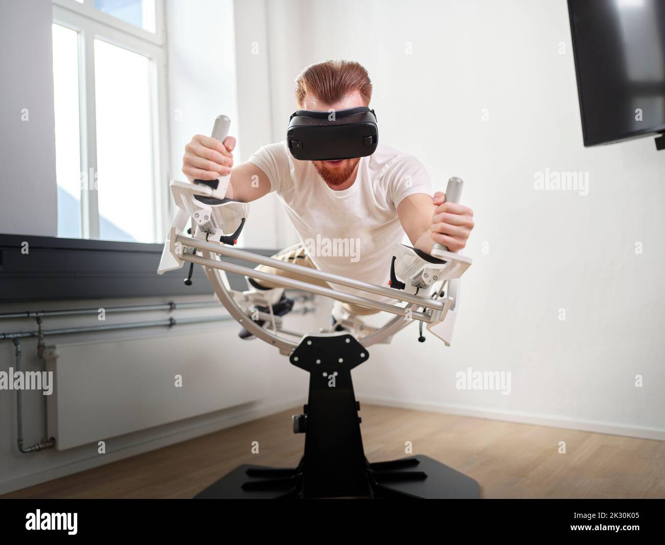 Young man wearing VR glasses practicing flight simulator Stock Photo ...