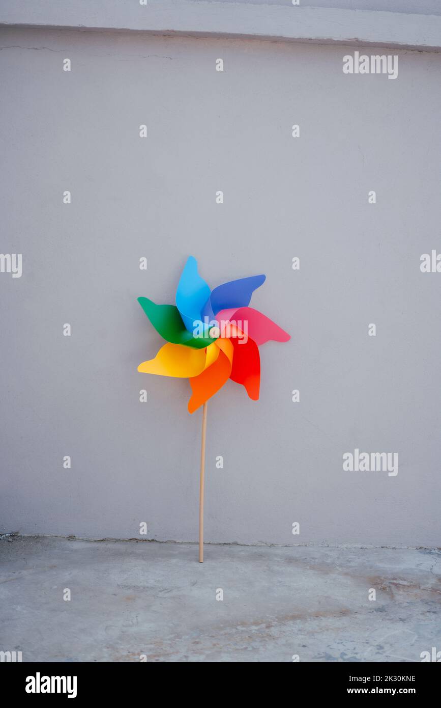 Multi colored pinwheel toy in front of wall Stock Photo - Alamy