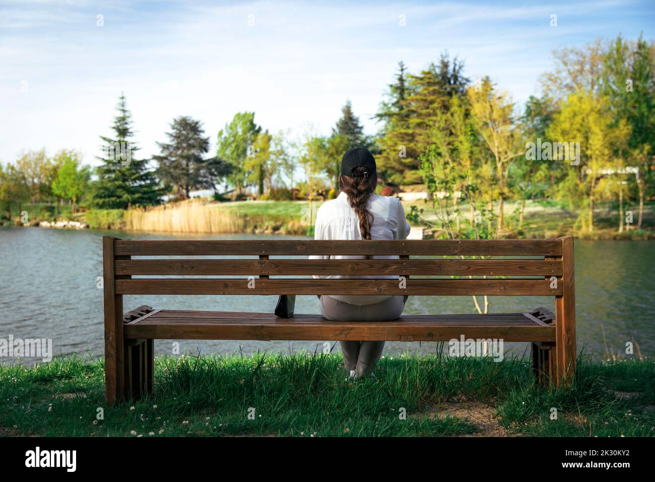 People sitting bench in front lake park bench hi-res stock photography ...