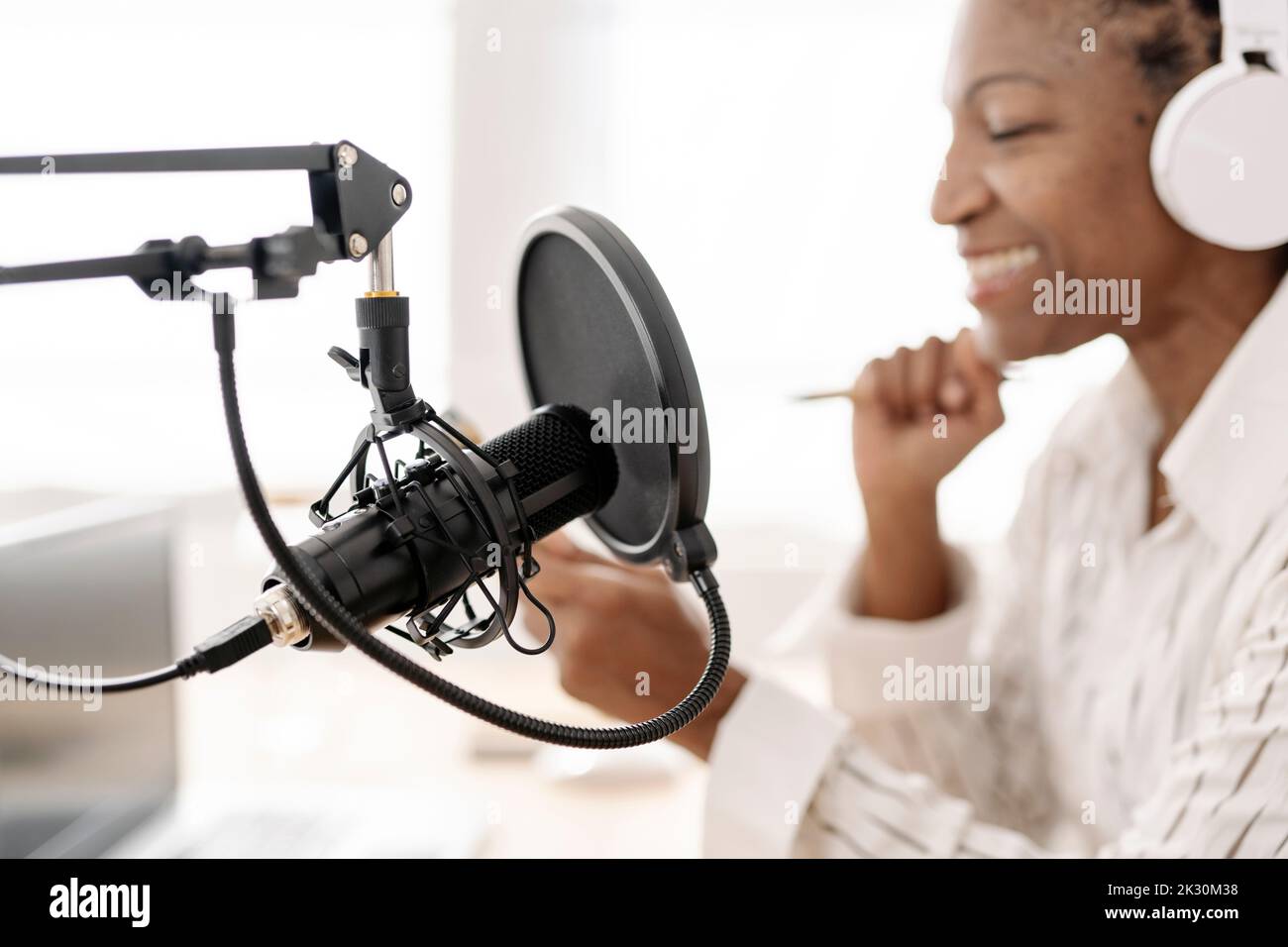 Smiling into microphone hi-res stock photography and images - Alamy